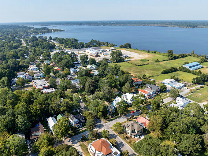 From above, New Bern reveals its perfect marriage of waterfront living and small-town charm, where the Neuse River embraces neighborhoods like an old friend.