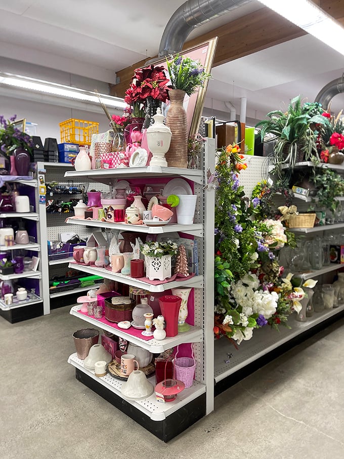 Pink vases, floral arrangements, and decorative containers create a pastel paradise. One shopper's castoffs become another's cherished home accents.