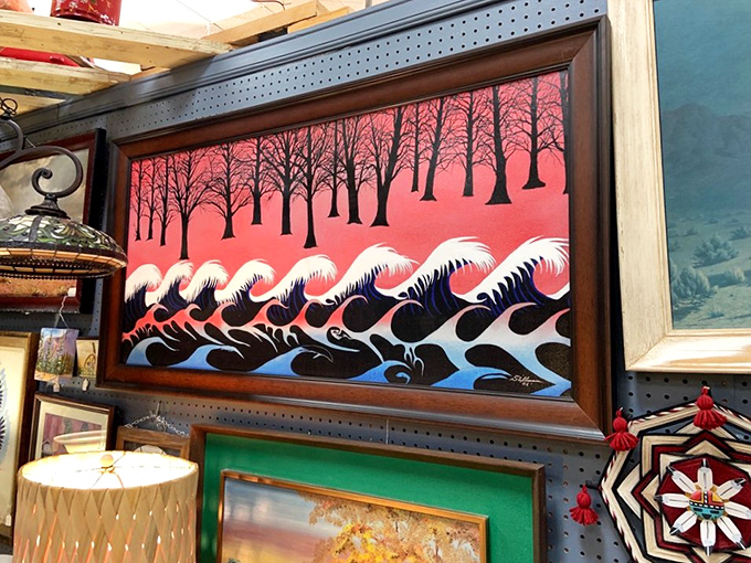 Where art meets nostalgia &ndash; this vibrant painting creates a striking focal point among the eclectic treasures, proving yesterday's decor can still make a statement today.