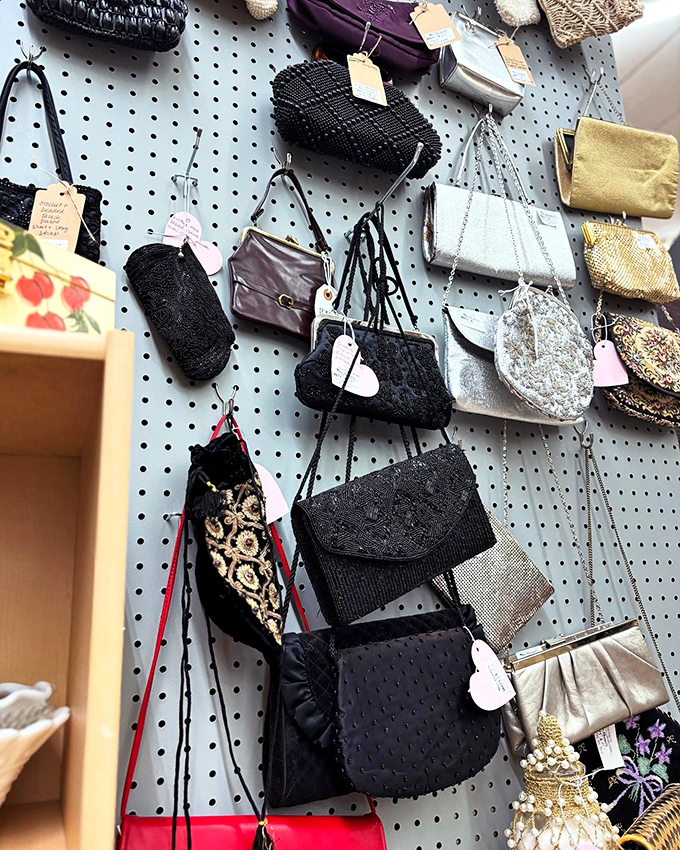 Vintage handbags hang like elegant ghosts of fashion past. Each beaded clutch and leather purse whispers stories of nights out decades ago.