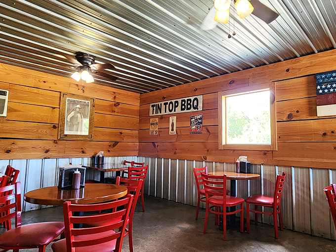 Warm wood paneling and bright red chairs create the perfect rustic backdrop for the serious business of barbecue consumption.