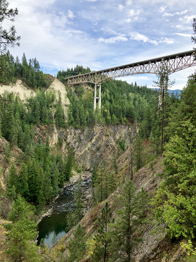 The steel truss bridge spans the canyon with elegant simplicity, a perfect frame for the natural masterpiece that lies below.
