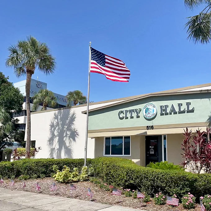 City Hall stands proudly under Florida's endless blue sky. Small-town governance where they still remember your name and probably your dog's too.