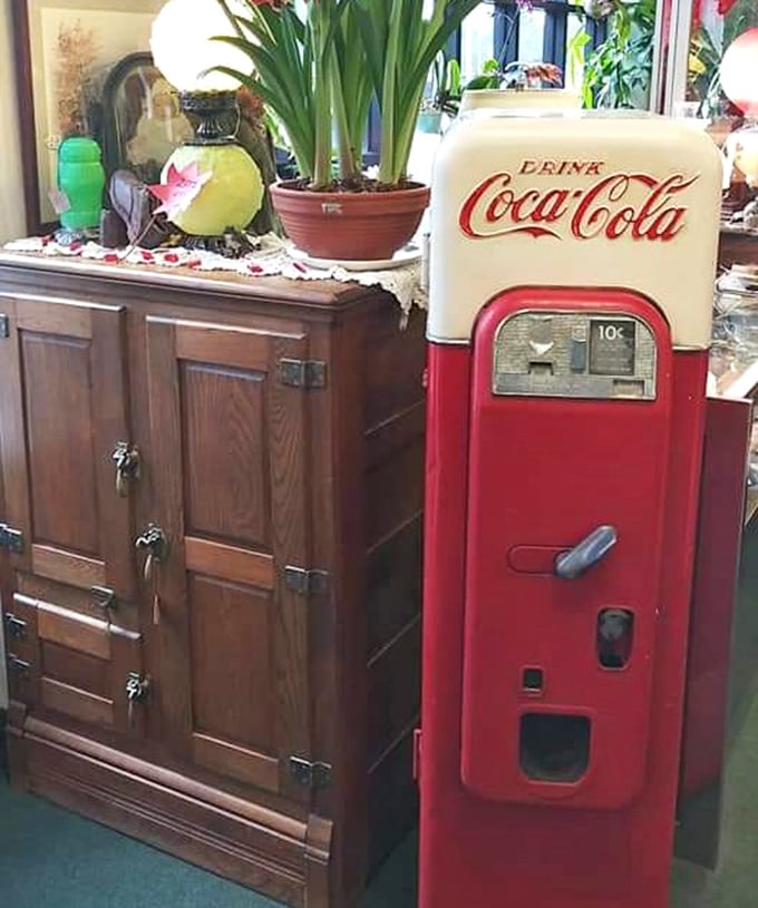 This vintage Coca-Cola machine stands as a crimson sentinel of simpler times, when a dime bought happiness and cavities came free.