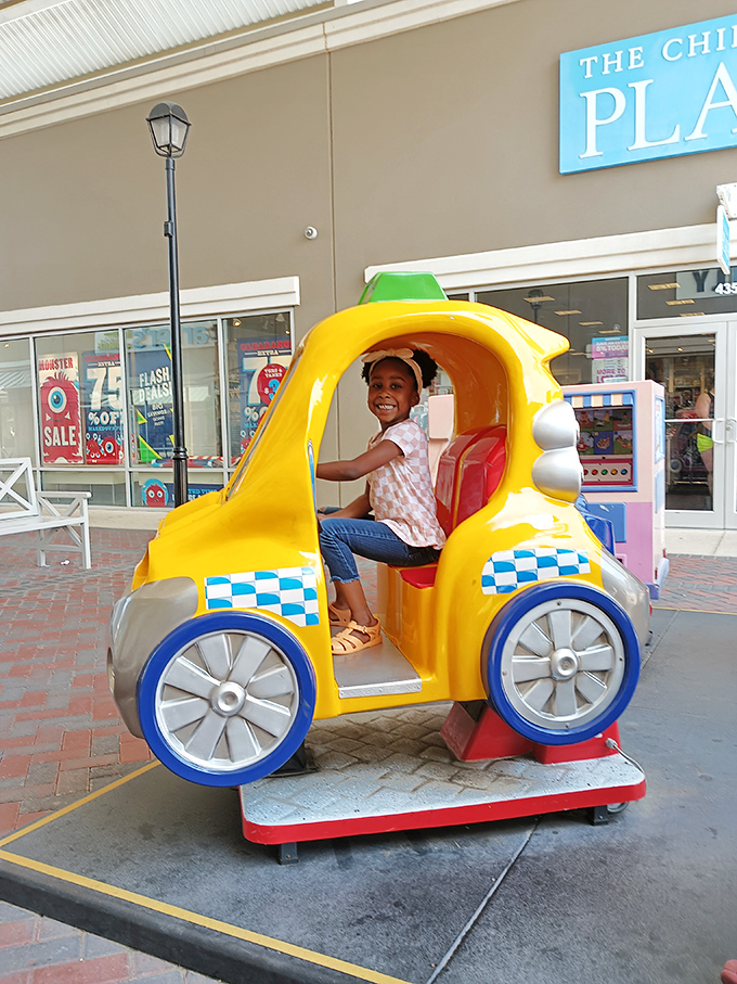 Childhood joy comes in bright yellow packages! This coin-operated taxi ride offers kids a moment of delight between shopping adventures. 