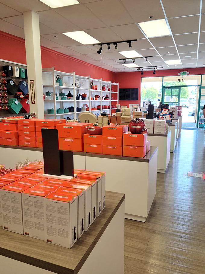 Le Creuset's signature orange boxes stack like a culinary treasure chest, each containing cookware that turns even microwave maestros into gourmet chefs.