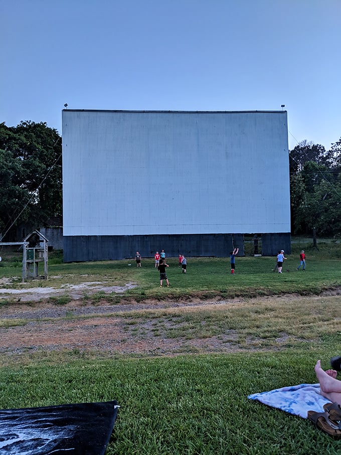 Before the show begins, kids make the most of daylight hours, turning the grassy area beneath the towering screen into their personal playground.