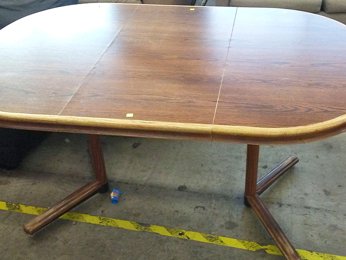 Mid-century modern meets bargain hunter's dream. This solid wood dining table is just waiting for its second act in someone's home.
