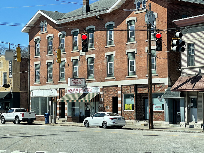 Historic brick buildings line downtown Thomaston, where traffic jams involve three cars and everyone knows which one belongs to the postmaster.