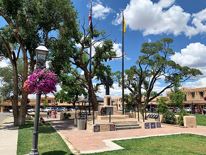 The Taos Plaza, where flags wave proudly and hanging flower baskets add splashes of color to the high desert palette.