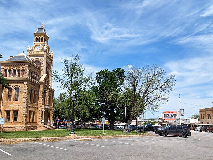 The Llano County Courthouse commands attention with its pink granite facade and clock tower &ndash; Texas' way of saying "time moves differently here."