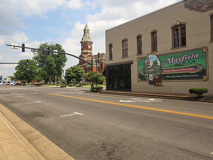 The iconic courthouse clock tower stands sentinel over Mayfield like a community timekeeper, while the welcoming town sign promises memories waiting to be made.