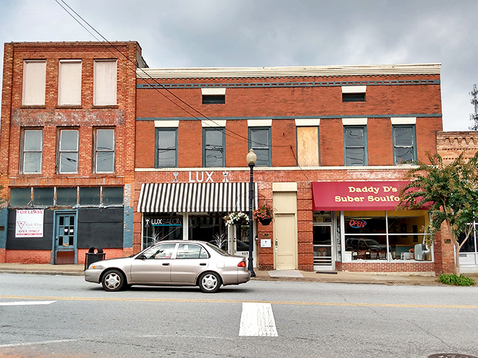 Main Street's charming storefronts invite leisurely exploration, with Daddy D's Suber Soulfood promising comfort food that hugs your insides like a warm blanket.