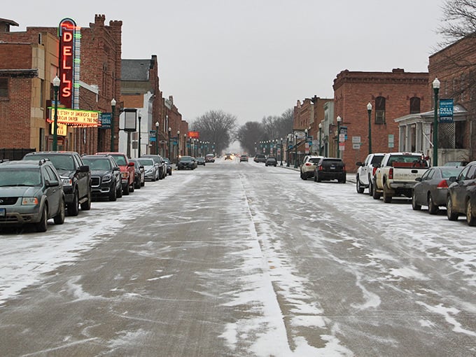 Winter transforms Main Street into a snow-dusted postcard, where the historic Dells Theatre marquee glows like a beacon of affordable entertainment.
