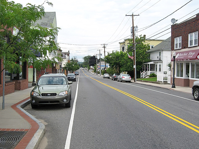 Main Street's gentle curve invites exploration, with colorful storefronts promising discoveries that chain stores simply can't deliver. Small-town America at its finest.