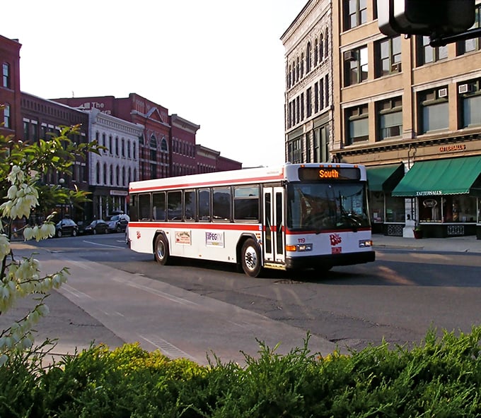 The city bus rolls through Rutland's downtown like a time machine connecting past and present, ferrying locals through streets lined with century-old buildings.