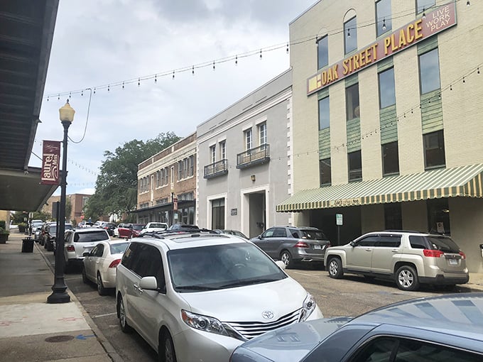 Oak Street Place stands proudly among Laurel's revitalized buildings, where string lights promise evening magic in this small-town renaissance.