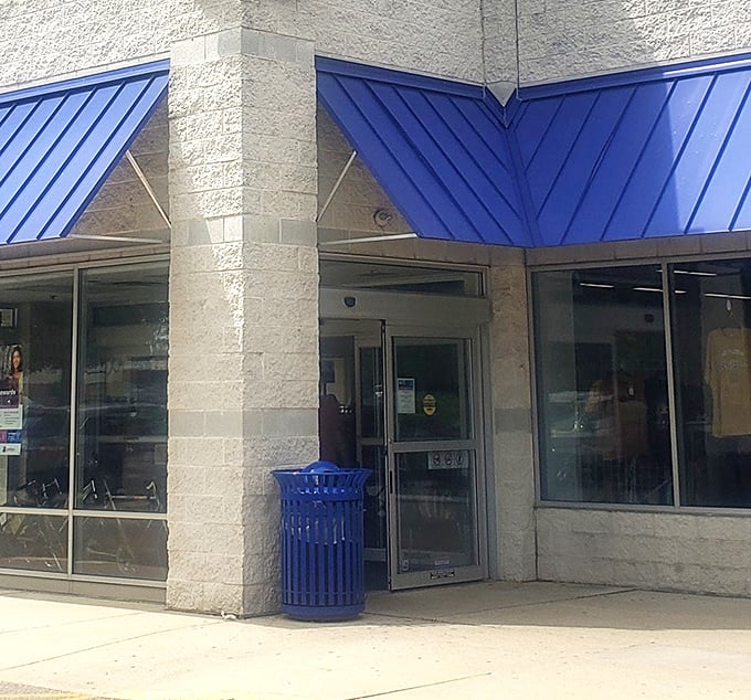 The blue-trimmed entrance beckons bargain seekers inside. Even the trash can coordinates with Goodwill's signature color scheme.
