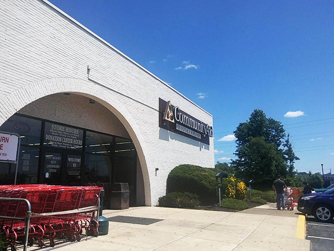 The grand entrance beckons shoppers with its distinctive arch, a portal to possibility where red carts await your thrifting adventure.
