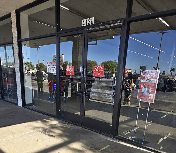 Sale signs promise 50% off treasures beyond these doors&mdash;like a game show where everyone wins and the grand prize might be a vintage leather jacket.