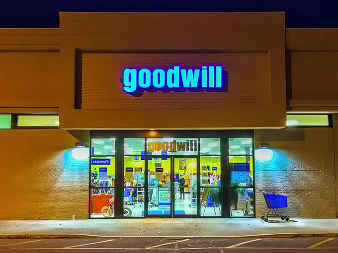 By night, the Goodwill transforms into a glowing blue portal to thrift paradise, beckoning night owls to dream of tomorrow's discoveries.