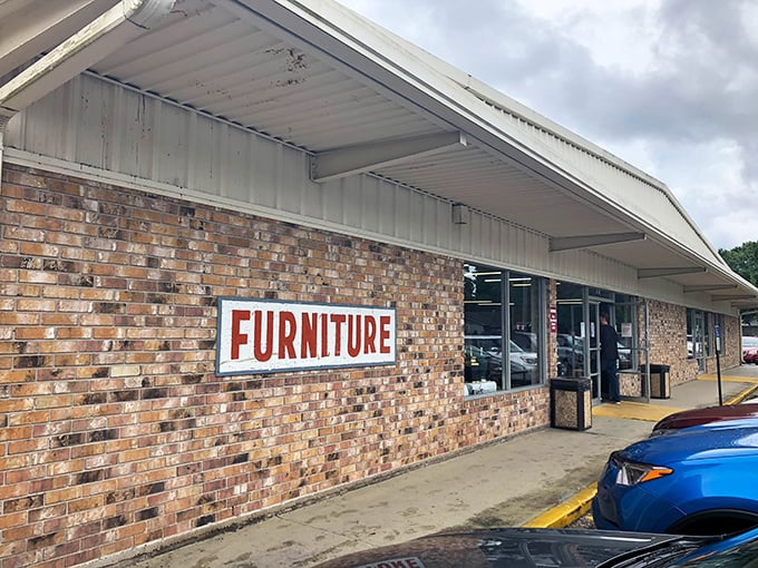 Bold red "FURNITURE" signage promises affordable home makeovers. One person's castoff sofa is another's living room centerpiece waiting to happen.