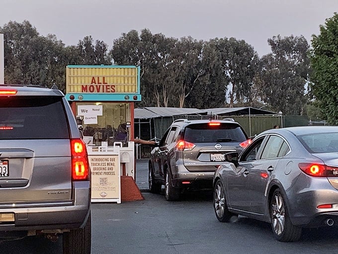 "ALL MOVIES" proclaims the vintage marquee as cars line up for their evening entertainment&mdash;a ritual that feels delightfully unchanged since the Eisenhower administration.