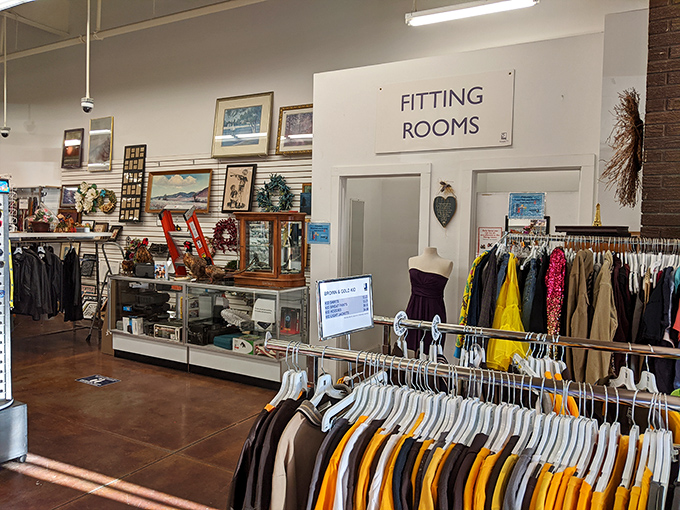 The fitting rooms stand ready for your fashion adventures, surrounded by framed art waiting for new walls to call home.