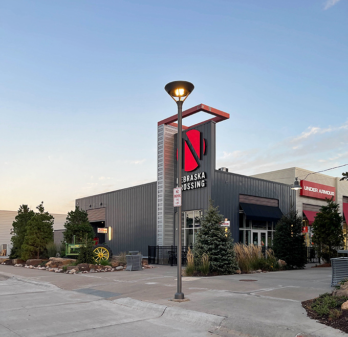 Sunset casts a golden glow on Nebraska Crossing's modern architecture, transforming an outlet mall into something almost poetic.