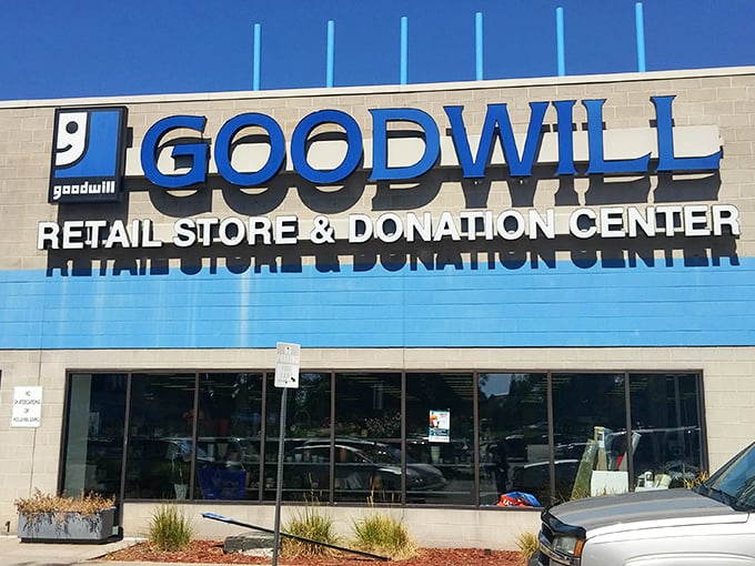 Bold blue lettering against beige concrete promises an adventure where one person's castoffs become another's conversation pieces.