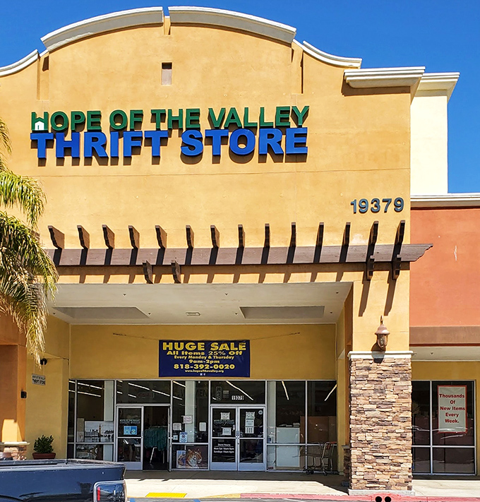 Like a desert mirage, the warm stucco facade promises retail salvation. That blue "HUGE SALE" banner isn't kidding&mdash;prepare your shopping stamina!