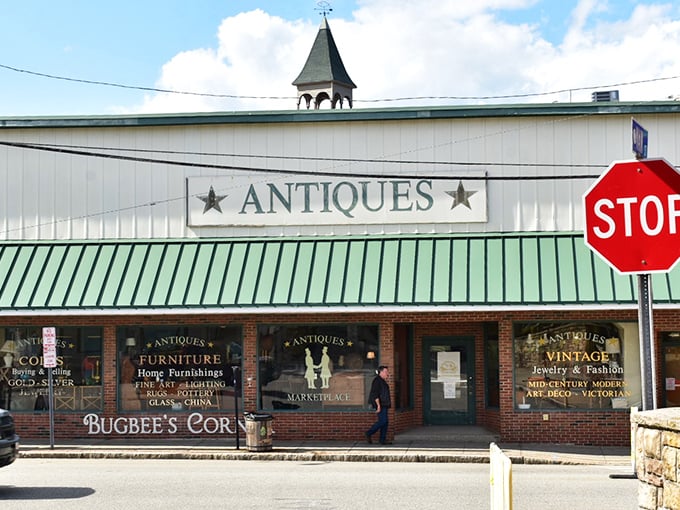 That iconic green roof and "ANTIQUES" sign – the architectural equivalent of a treasure map's big red X. Adventure awaits beyond those brick walls.