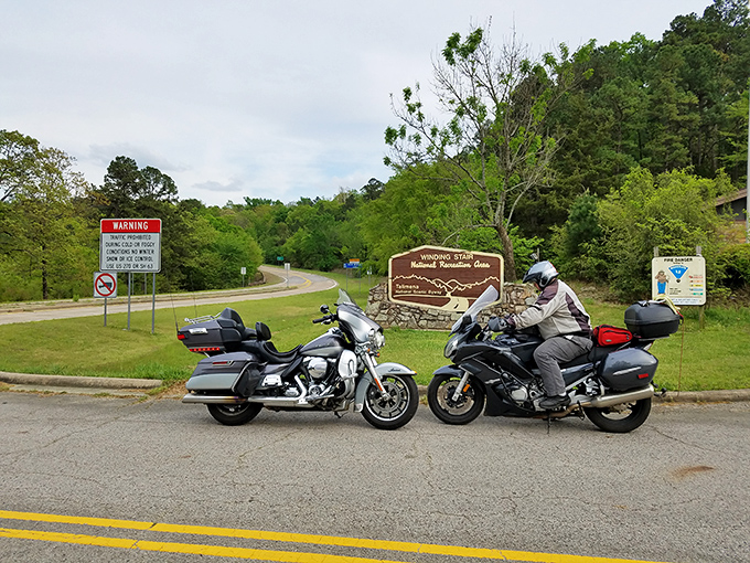 Motorcycle heaven awaits at the entrance. These riders know the secret - two wheels might just be the perfect way to experience this winding masterpiece.