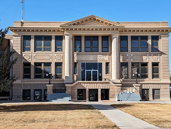 The Goshen County Courthouse stands like a dignified elder statesman, its columns and symmetry a testament to when civic buildings inspired awe.