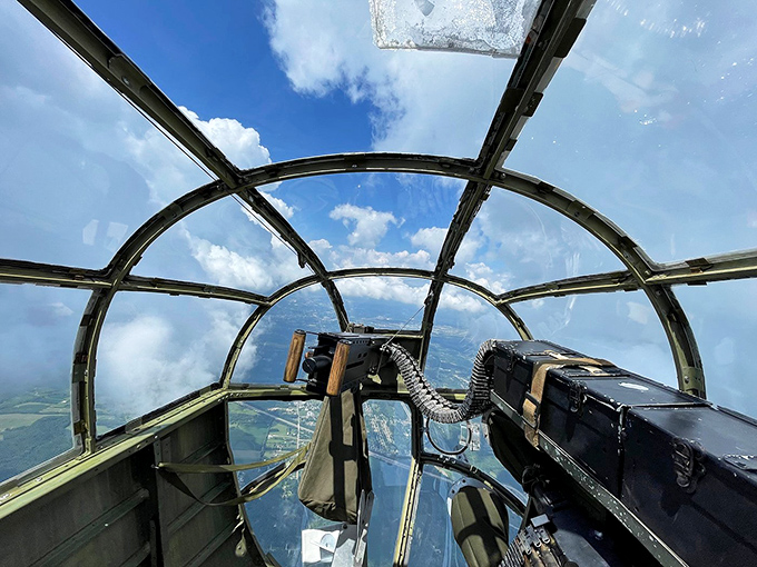 The bomber's glass nose offers a pilot's-eye view of history. From up here, the clouds tell stories of missions past.