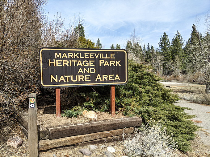 The Heritage Park sign promises exactly what retirement should: nature, history, and paths less traveled by hurried feet.