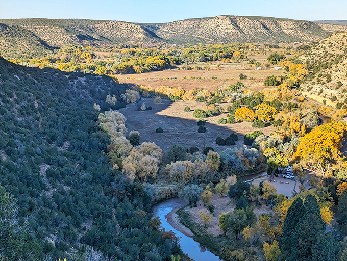 From up here, the Pecos River looks like a blue ribbon someone dropped through the canyon floor.