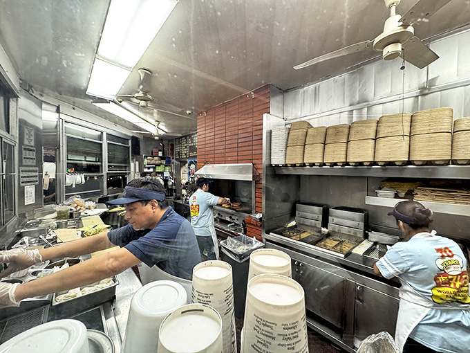 Behind the scenes, the magic happens: stacks of buns, flying hands, and pastrami dreams coming true.