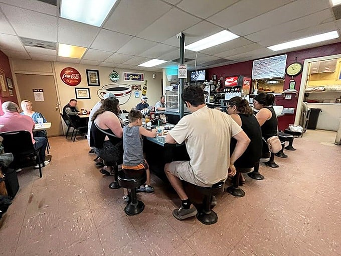 The horseshoe counter creates instant community—where strangers become breakfast buddies faster than eggs hit the griddle.