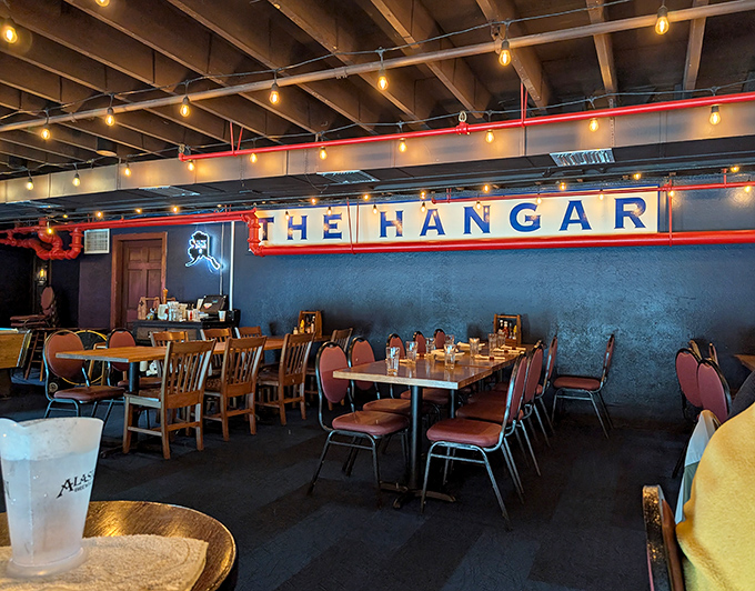 Inside, the warm glow of string lights transforms industrial bones into cozy refuge. That sign isn't just decoration&mdash;it's a promise of good things to come.