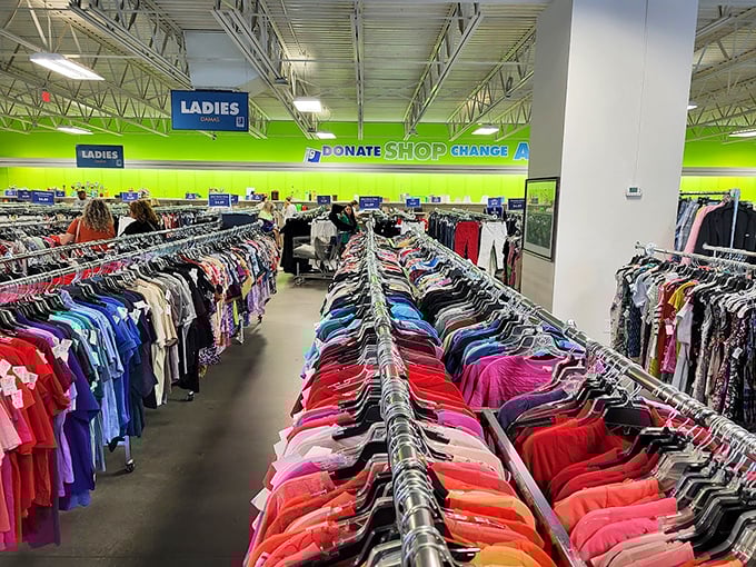 Rainbow rows of clothing stretch toward the horizon like a textile Grand Canyon. The lime green walls aren't just decorative—they're motivational shopping psychology at work.