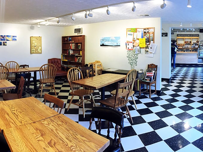 Classic black and white checkered floors meet mismatched wooden chairs&mdash;this isn't Instagram-designed decor, it's authentically charming and genuinely welcoming.