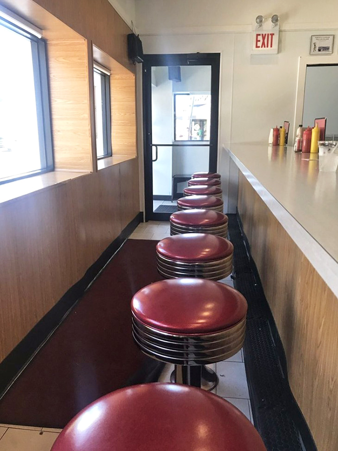 Those iconic red vinyl stools lined up like soldiers ready for duty. Slide onto one and join the ranks of satisfied diners spanning generations.
