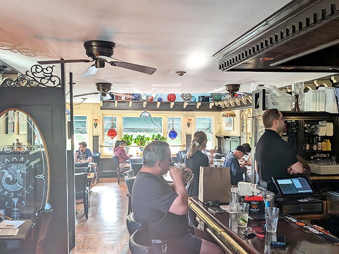Ceiling fans lazily spin above the cozy bar where locals swap fishing tales and visitors discover Rhode Island's briny bounty.