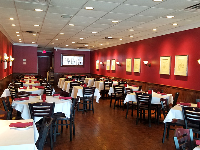 Red walls and white tablecloths create the kind of atmosphere where every meal feels like a special occasion.