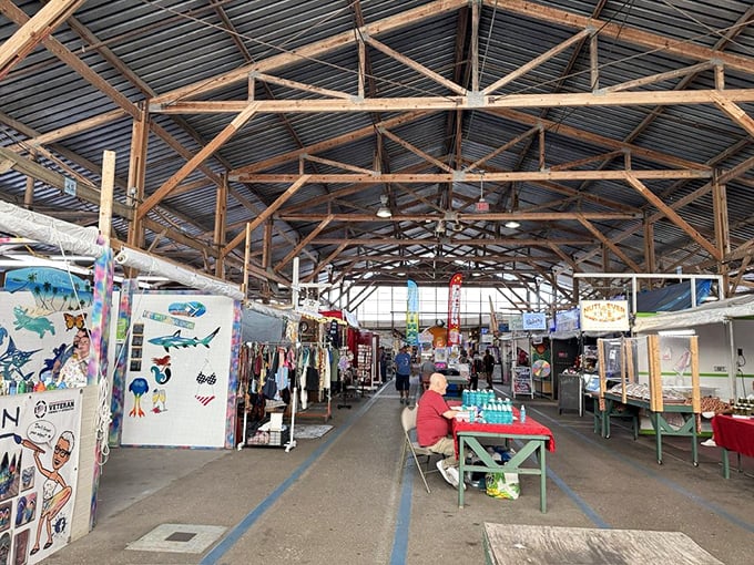 Beneath rustic wooden beams, shoppers navigate this indoor bazaar like explorers charting unknown territory, each booth a potential eureka moment.