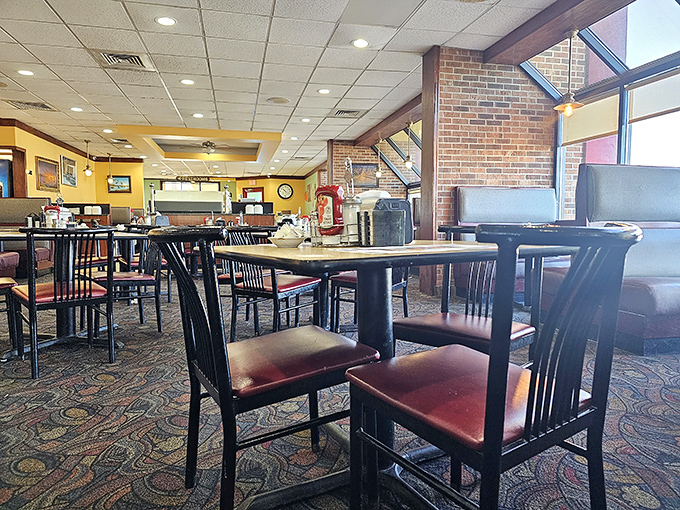 Classic diner ambiance with burgundy seats and warm lighting &ndash; the kind of place where calories don't count and coffee cups are never empty.