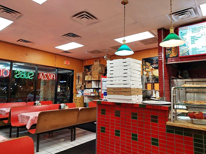Classic red-checkered tablecloths and stacked pizza boxes tell you everything: this place prioritizes substance over style, exactly as it should.