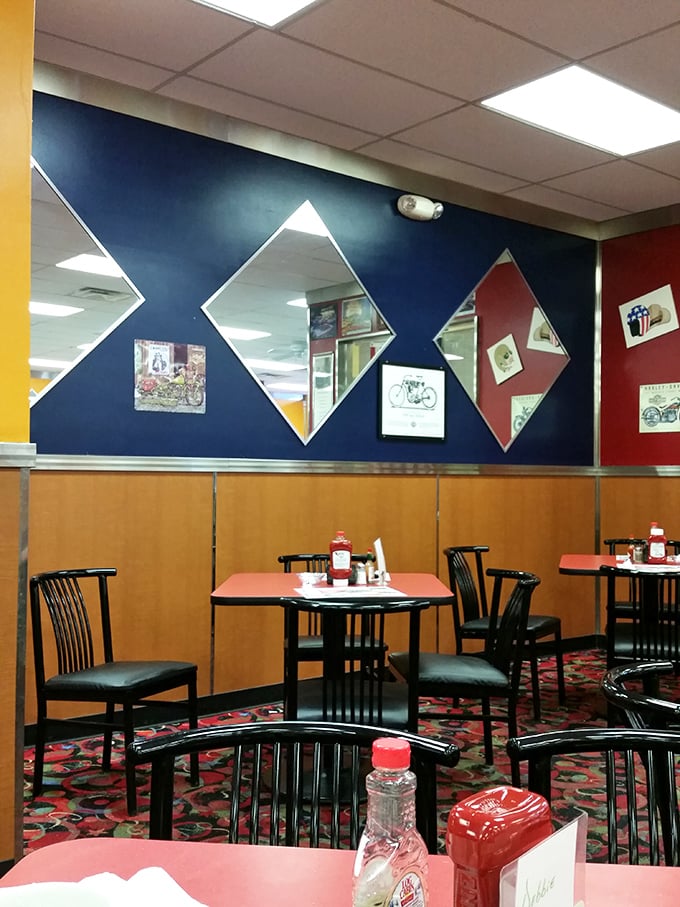 Diamond-shaped mirrors and patriotic decor create that classic American diner atmosphere where comfort trumps trendiness every time.