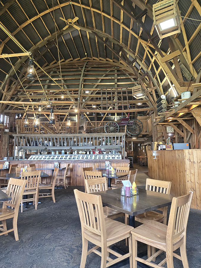 Soaring wooden beams create a cathedral of comfort food, where rustic charm meets hungry diners. The original barn architecture tells stories overhead while plates below create new memories.